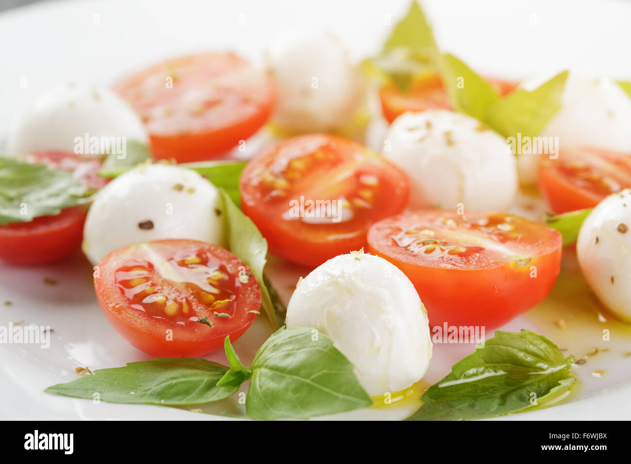 caprese salad with mini mozzarella balls and tomatoes Stock Photo - Alamy