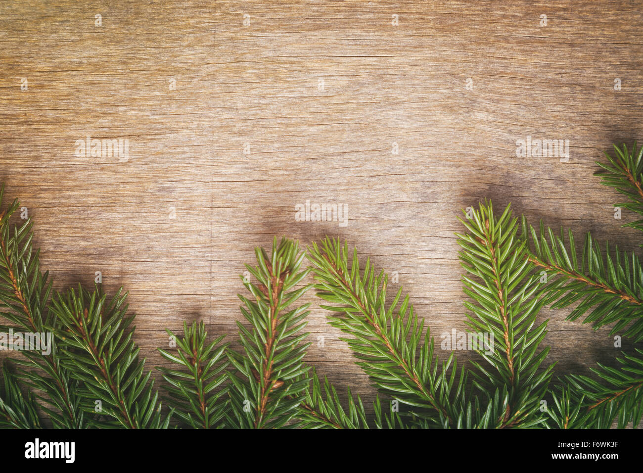 background with fir branch over wood table Stock Photo - Alamy
