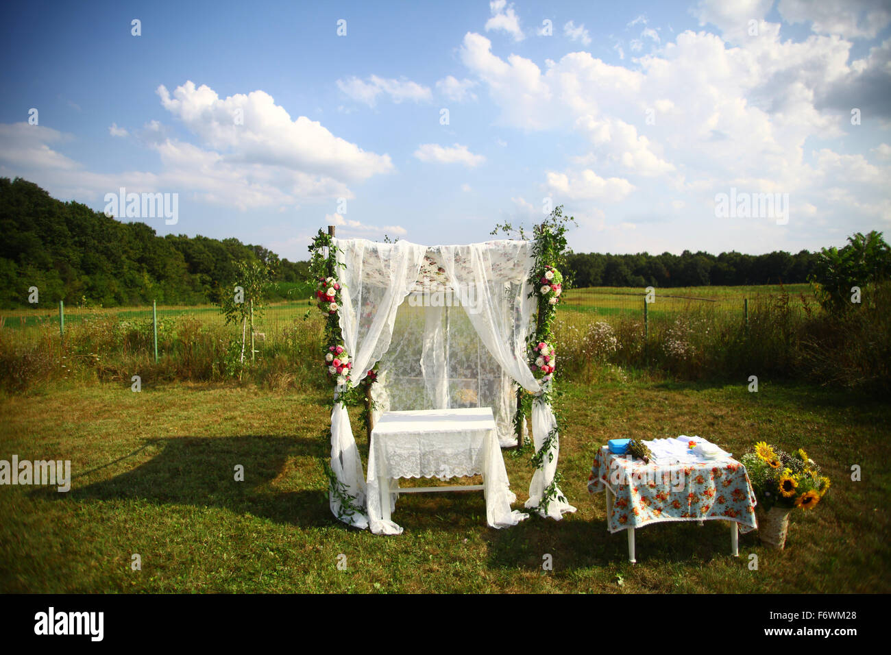 Color image of an outdoor marriage altar with flowers Stock Photo - Alamy