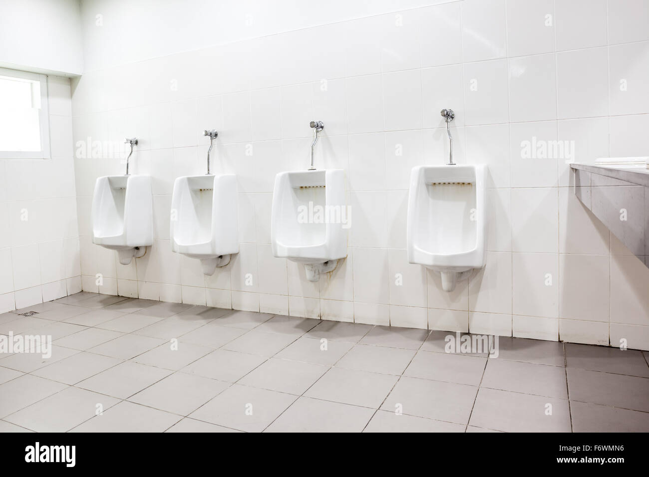 urinals in an old building for men only Stock Photo - Alamy
