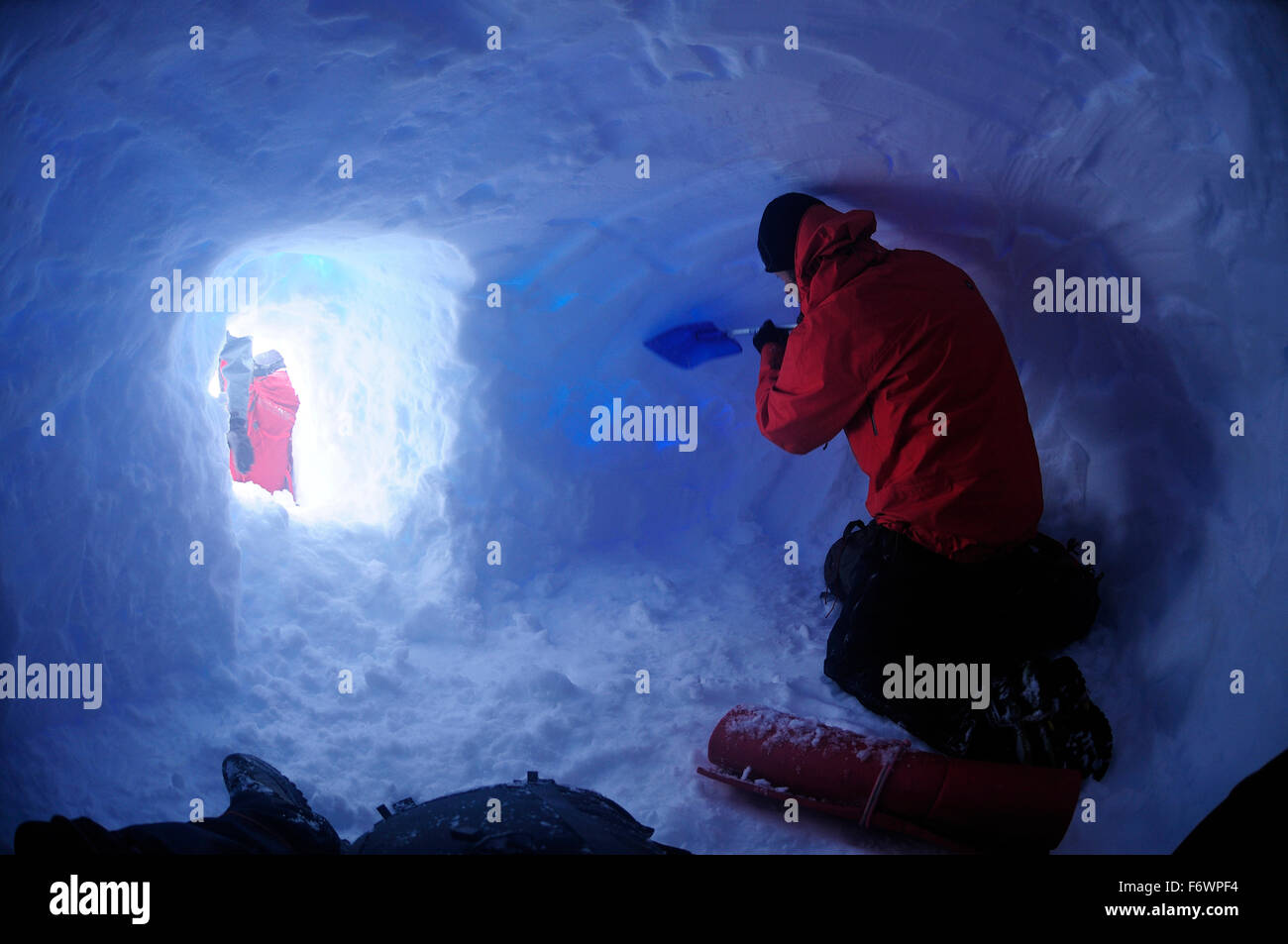 Mountaineer digging a snow cave at Collado Este, Monte Sarmiento ...