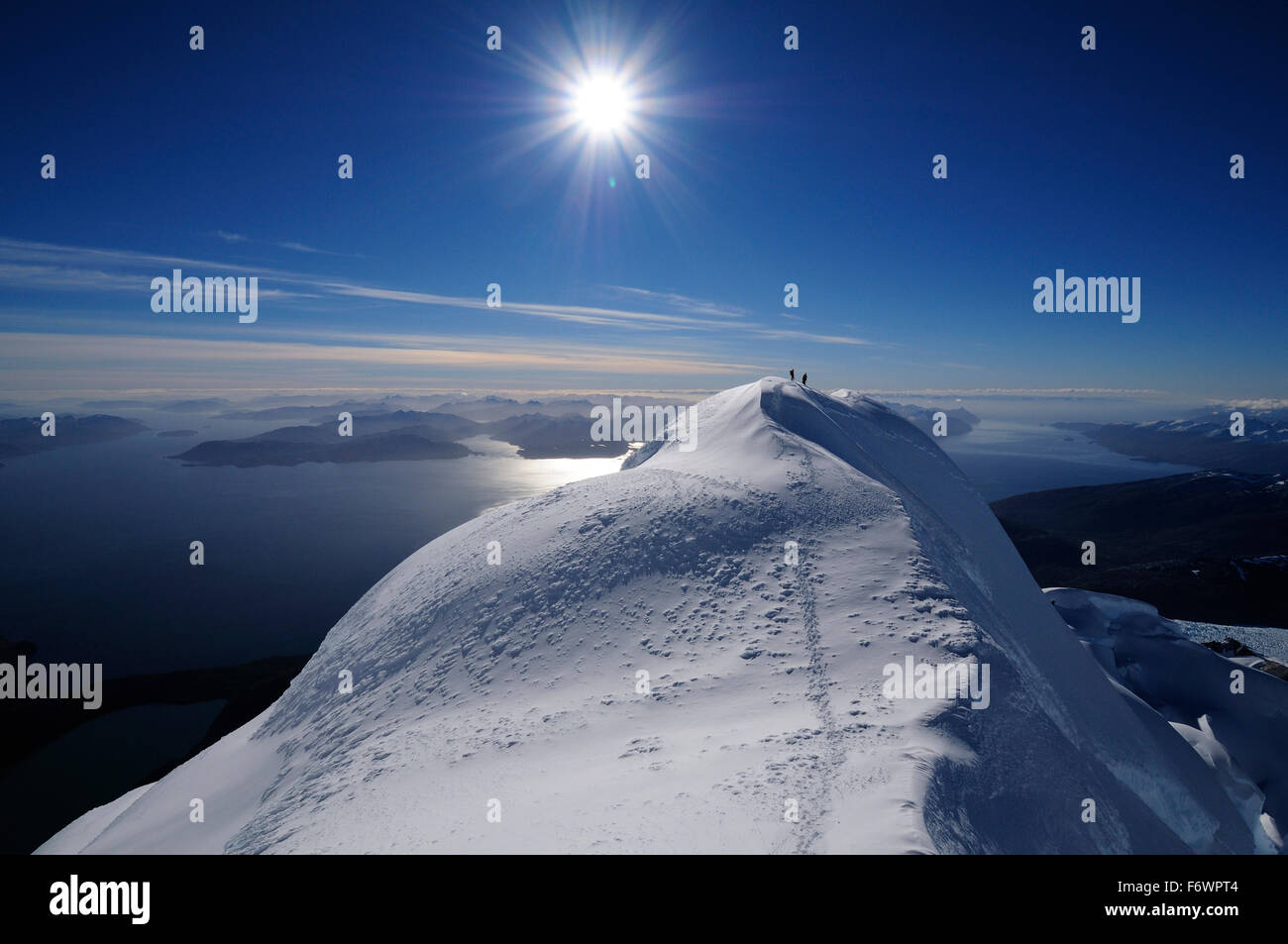 Two mountaineers on Monte Sarmiento, Strait of Magellan in background ...