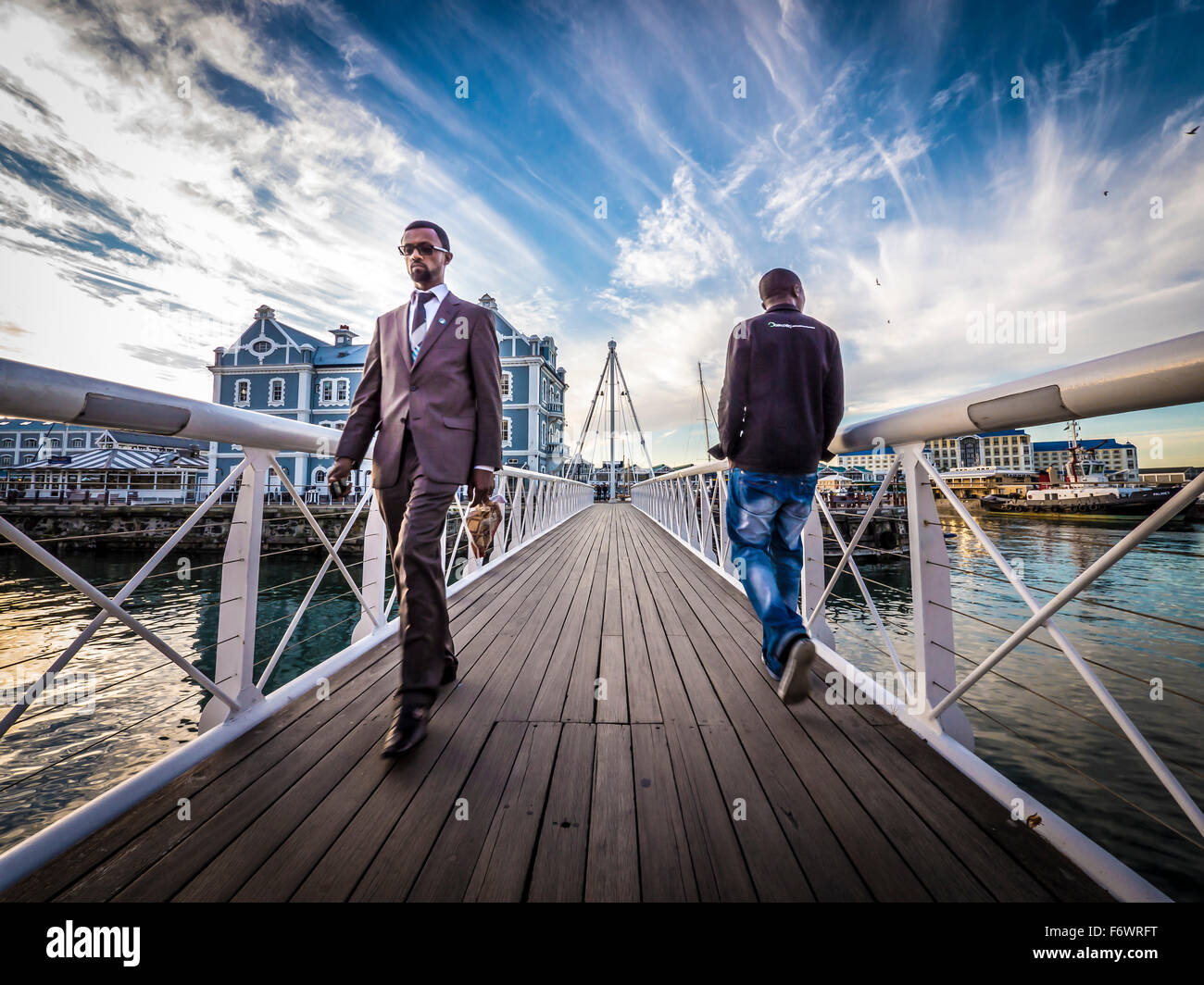 Two men passing a bridge, Victoria and Alfred Waterfront, Cape Town ...