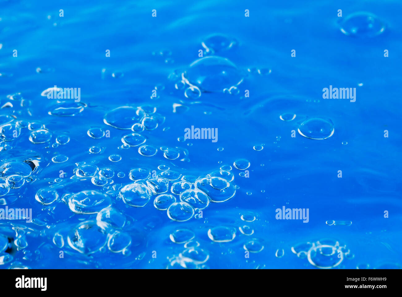 Blue water with water blister studio shot Stock Photo - Alamy