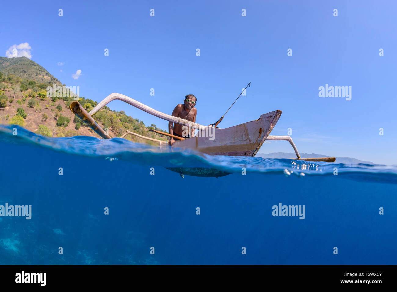Local Spear Fisherman with outrigger boat, Splitlevel picture, Alor ...