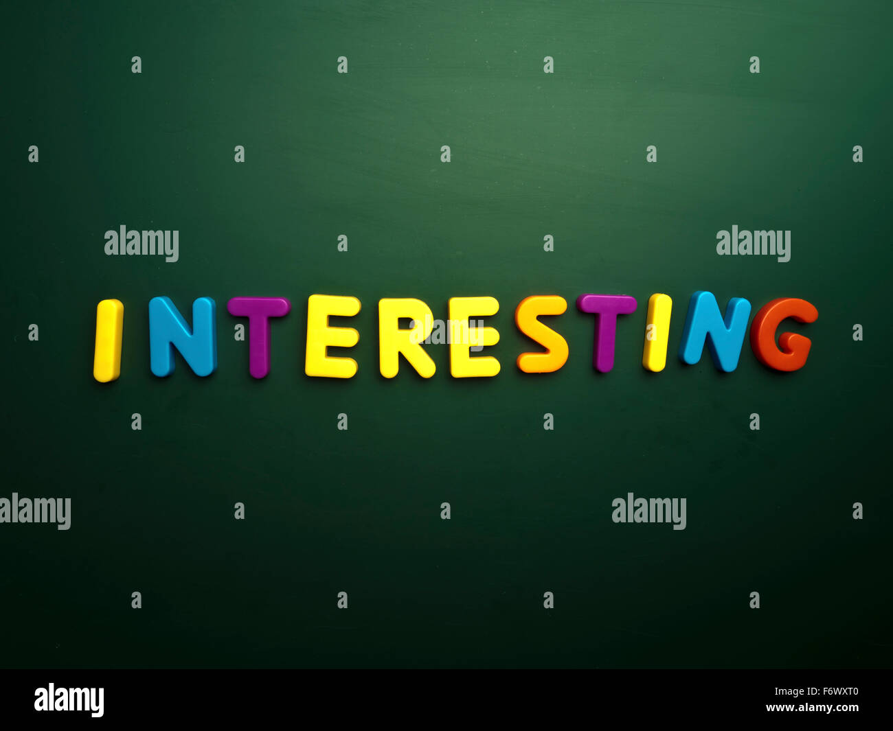 interesting concept in colorful letters isolated on blank blackboard ...