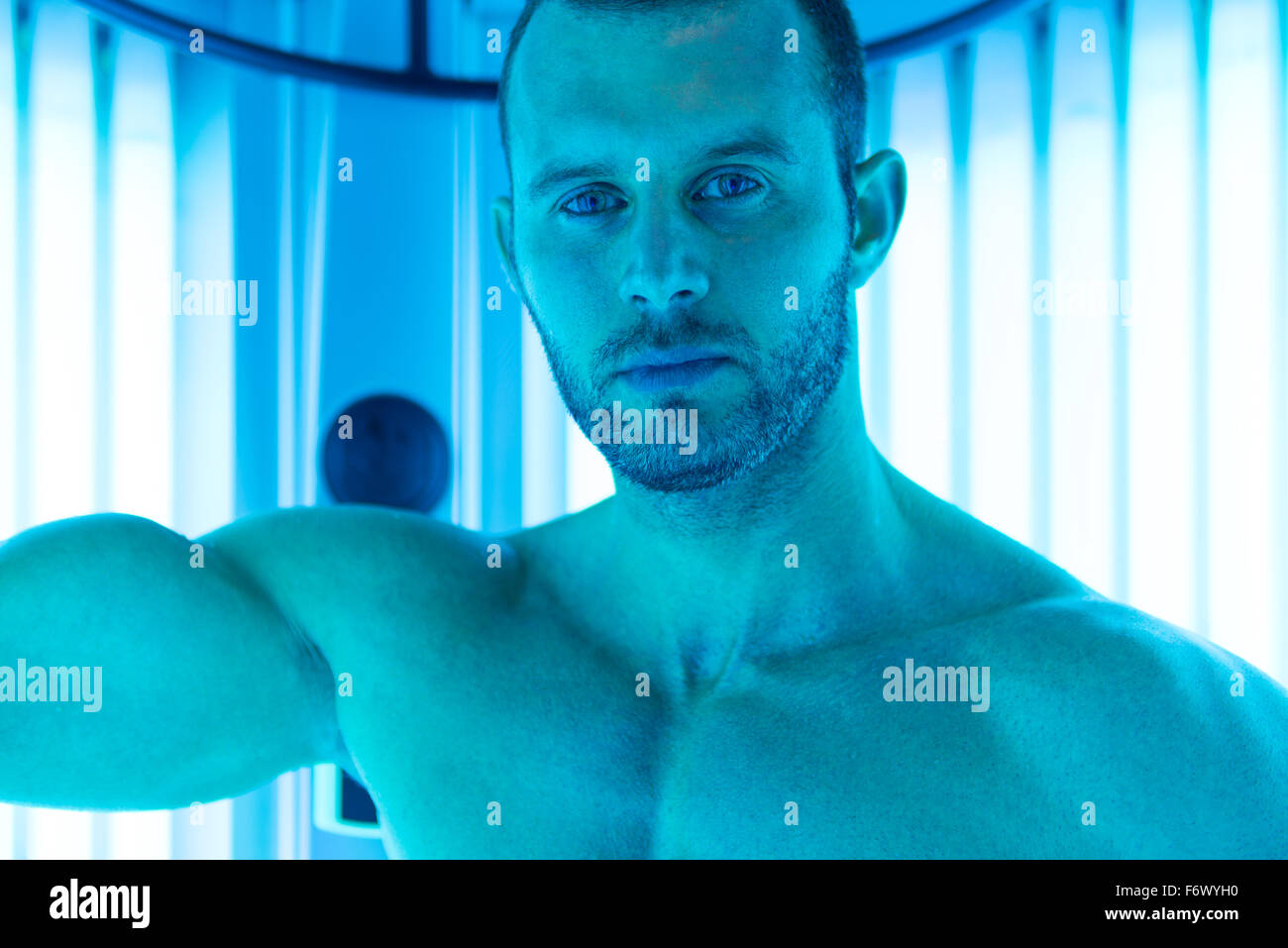 Young Muscular Man At Solarium In Beauty Salon Stock Photo - Alamy