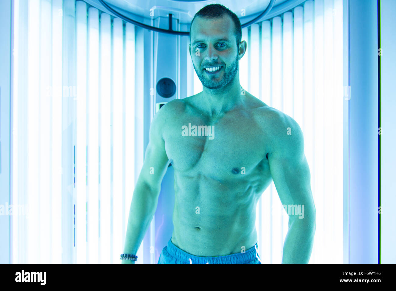 Young Muscular Man At Solarium In Beauty Salon Stock Photo - Alamy