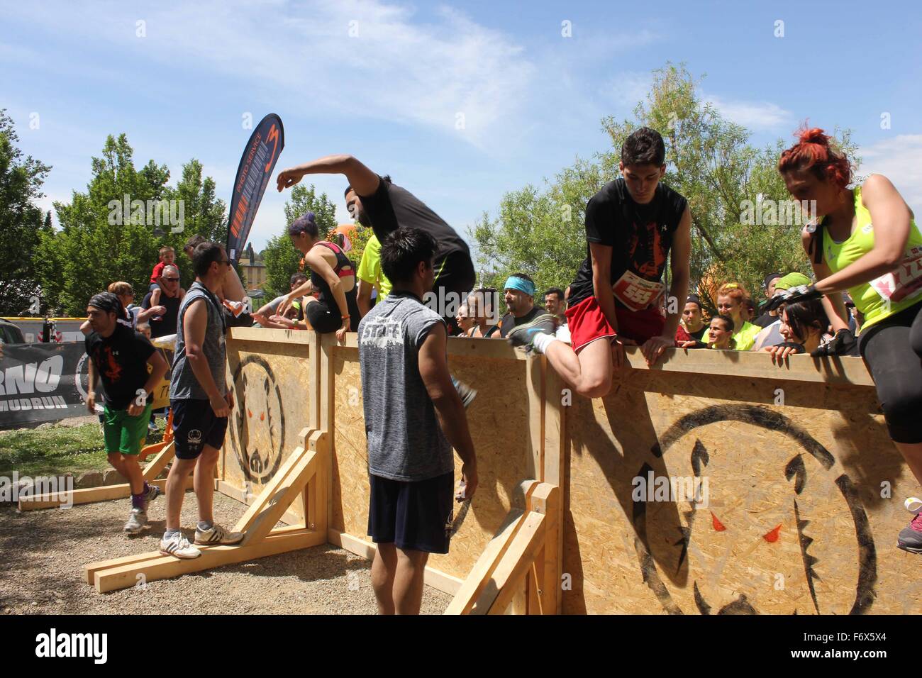 SIGNA, ITALY - MAY 9 2015: Group of people jumping over an obstacle ...