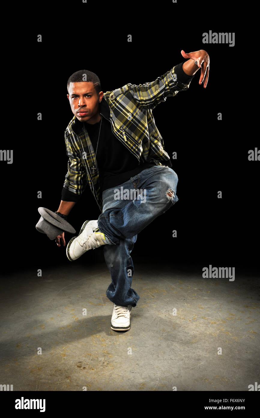 Young African American hip hop dancer performing over dark background ...