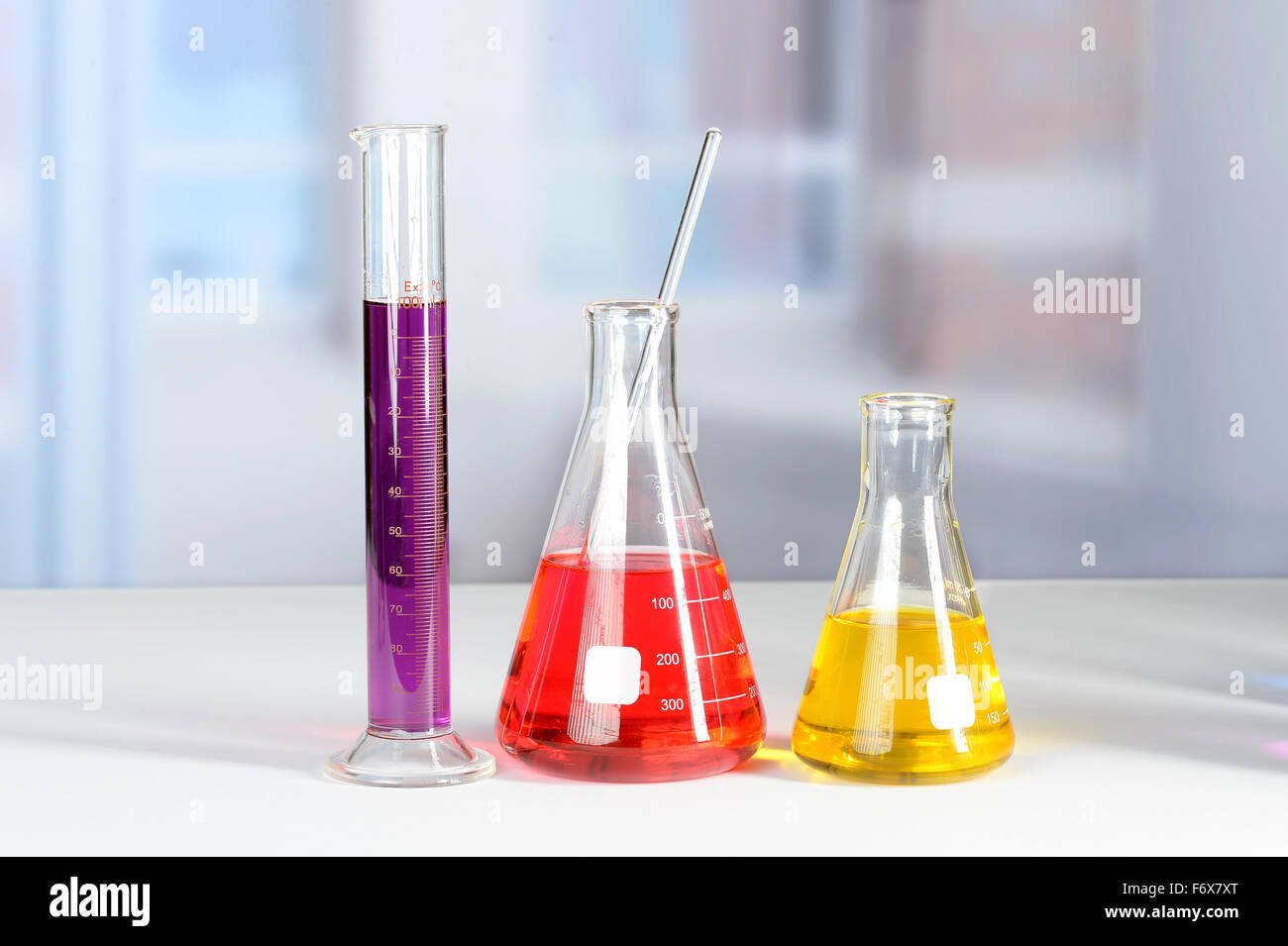 Laboratory glassware with colored liquids on lab table Stock Photo - Alamy