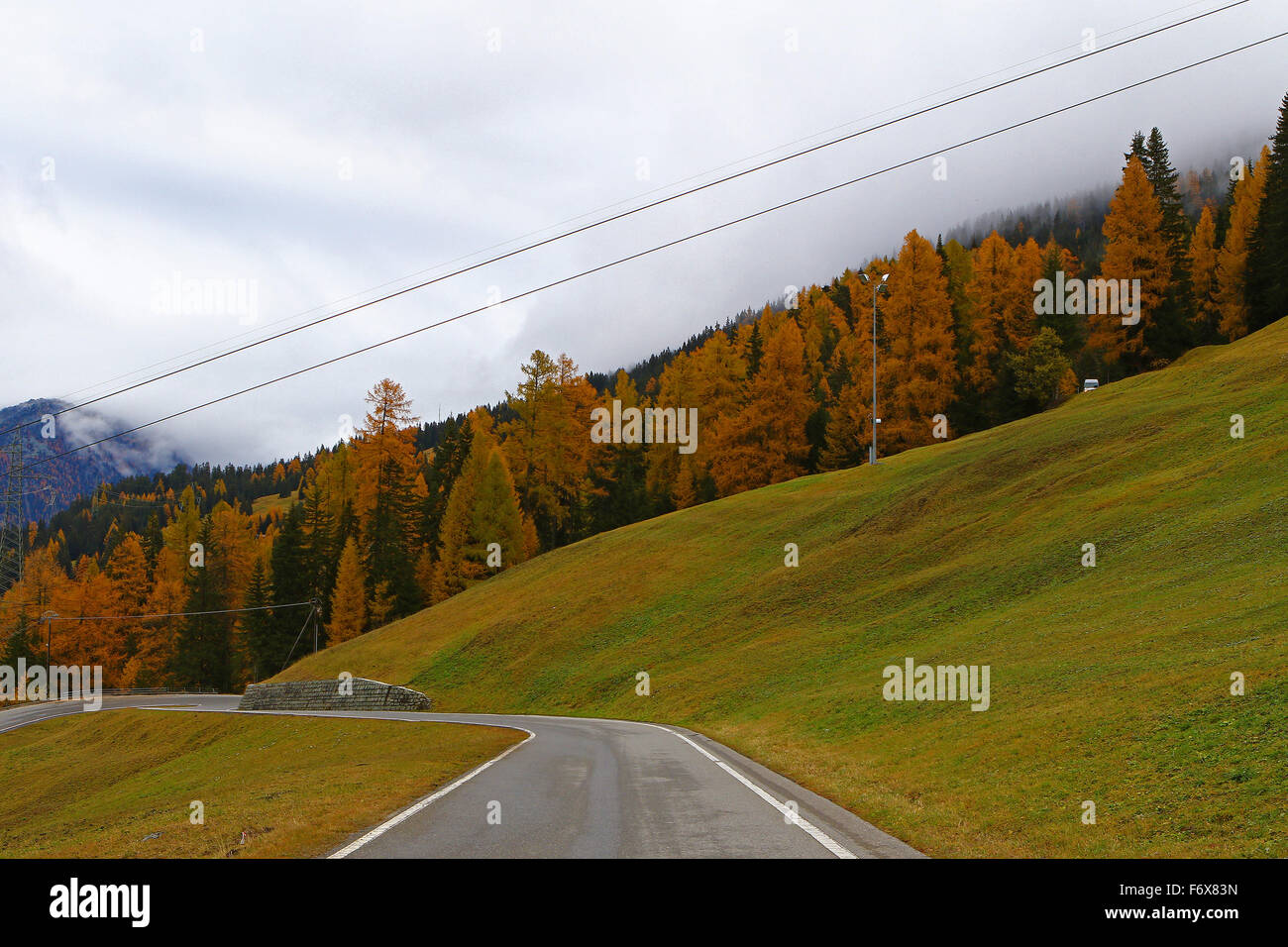 Splügen mountain pass road in the fall in rapidly changing weather ...