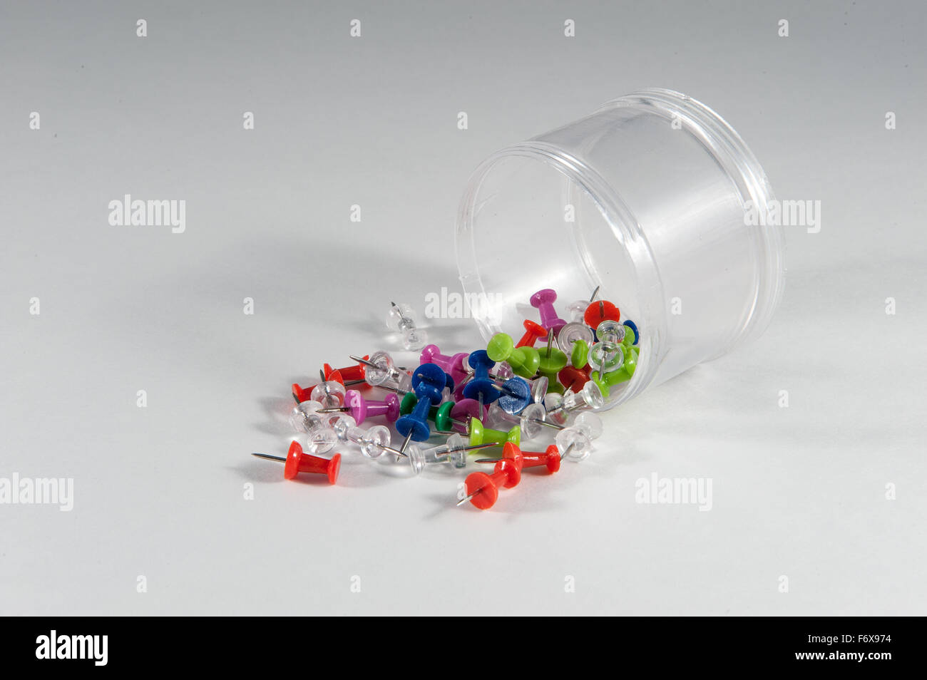 Container of push pins against a white background Stock Photo - Alamy