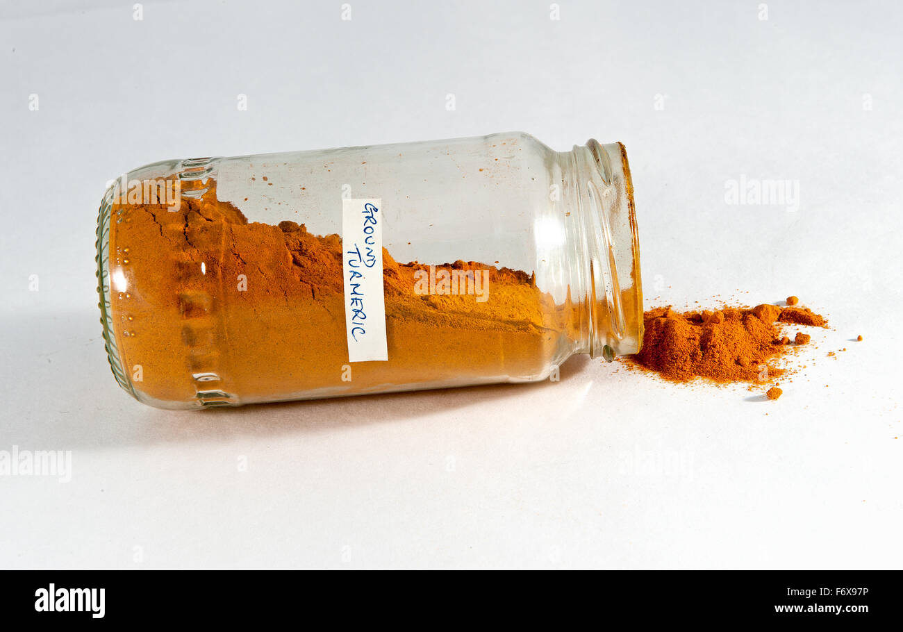 Spilled jar of Ground Turmeric against a white background Stock Photo ...