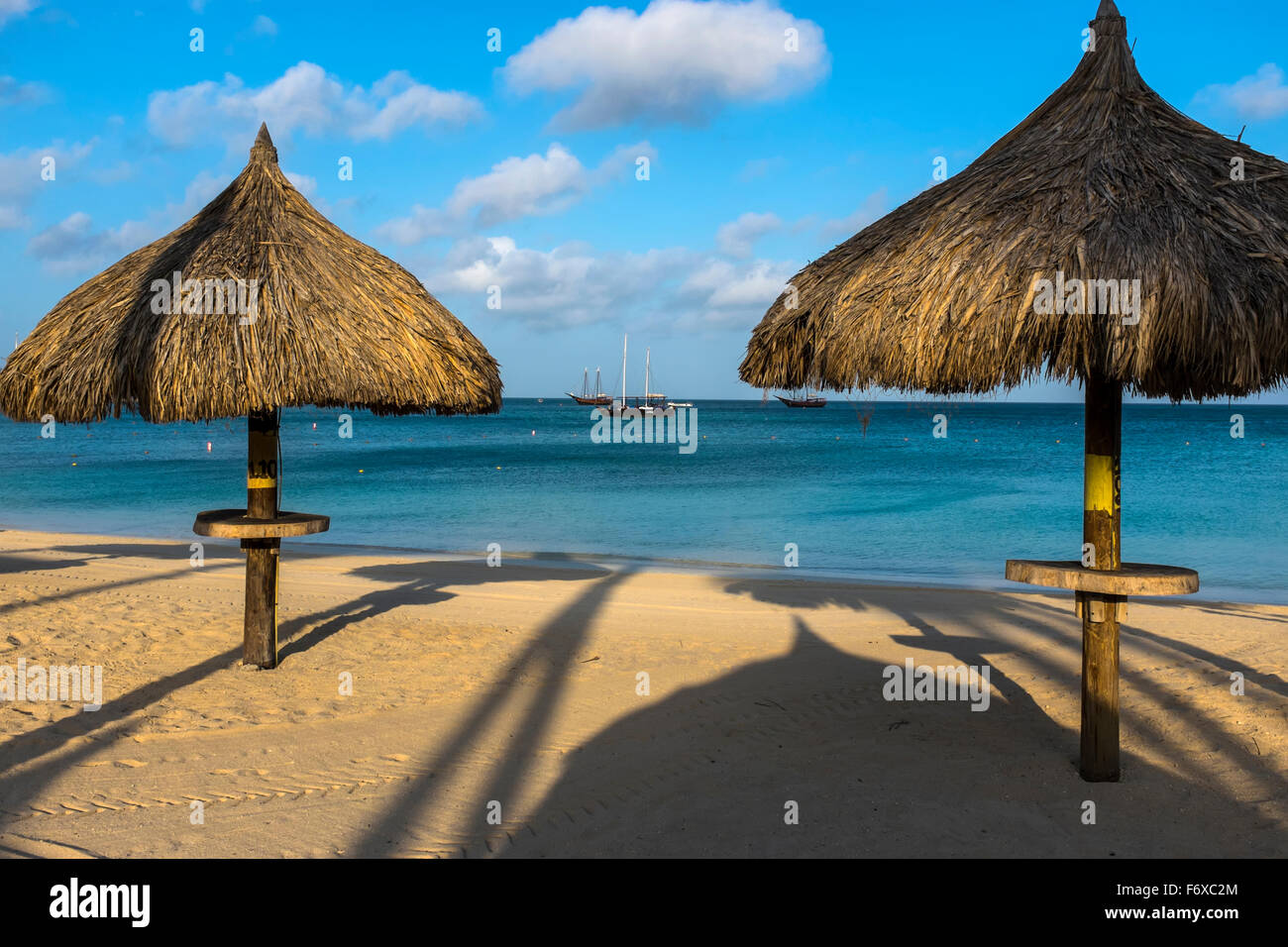 Beach palapas at Palm Beach with sailboats anchored close to shore ...
