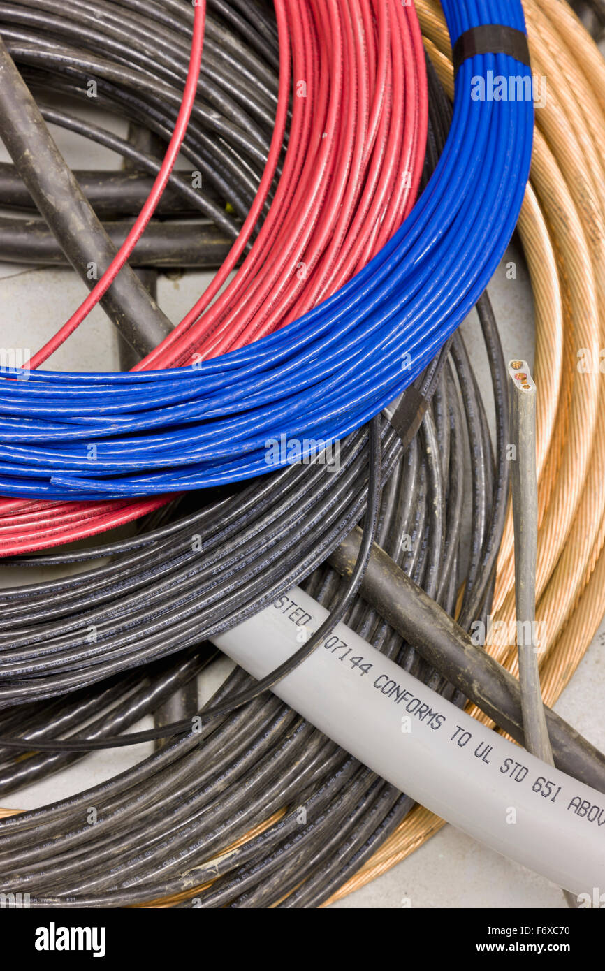 Coils of cable and cord hanging on a wall at an electrical power plant ...