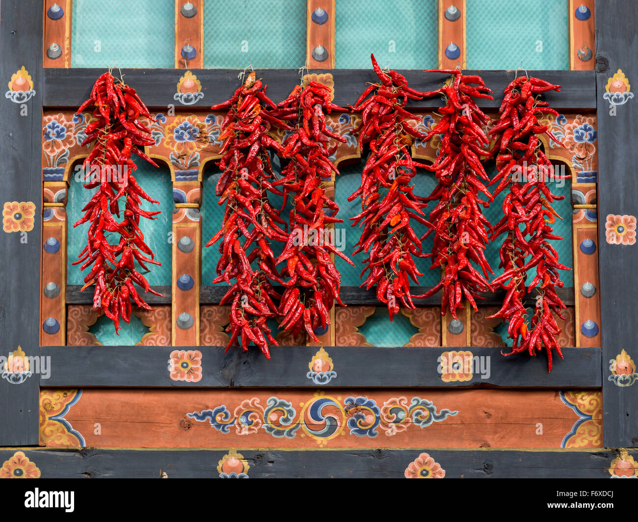 Red peppers hanging on an ornate wall; Paro, Bhutan Stock Photo - Alamy