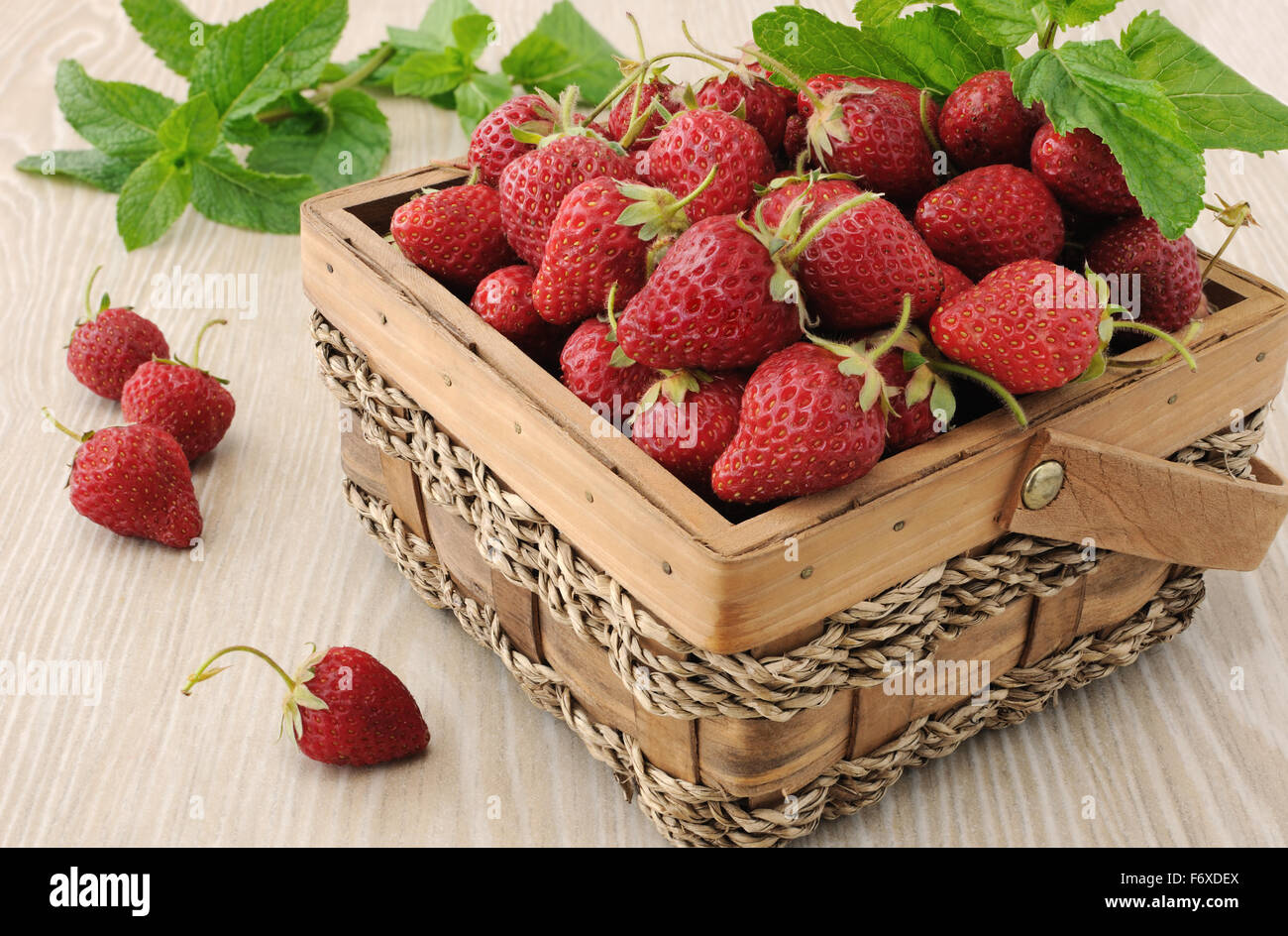 Ripe, juicy strawberries in a basket on the table close-up Stock Photo ...