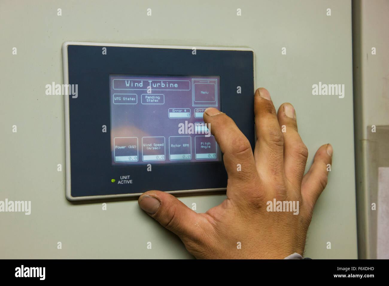 A male hand operating an electric control panel screen, in an electric ...