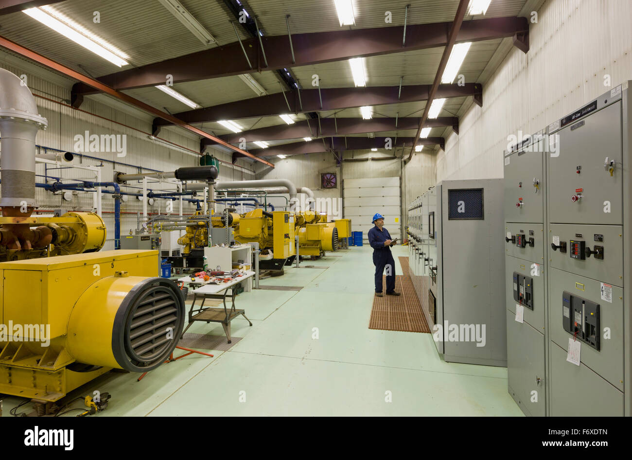Worker inspecting a control panel at a diesel power plant, Sand Point ...