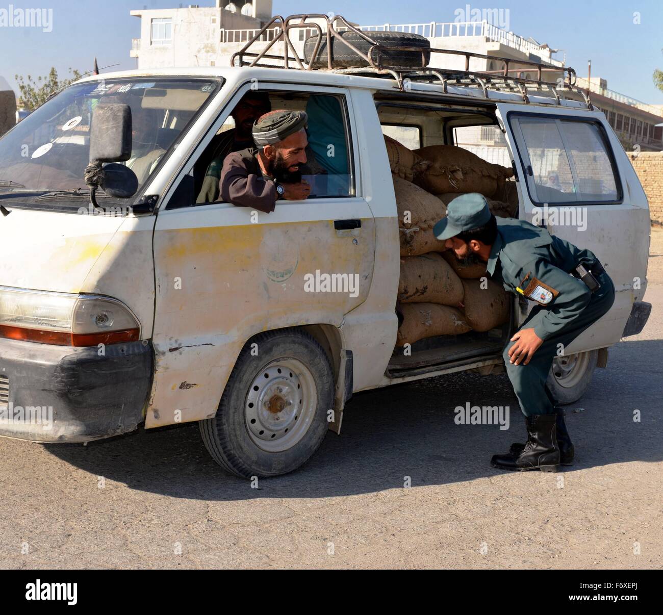 Kandahar. 21st Nov, 2015. An Afghan policeman searches a vehicle at a ...