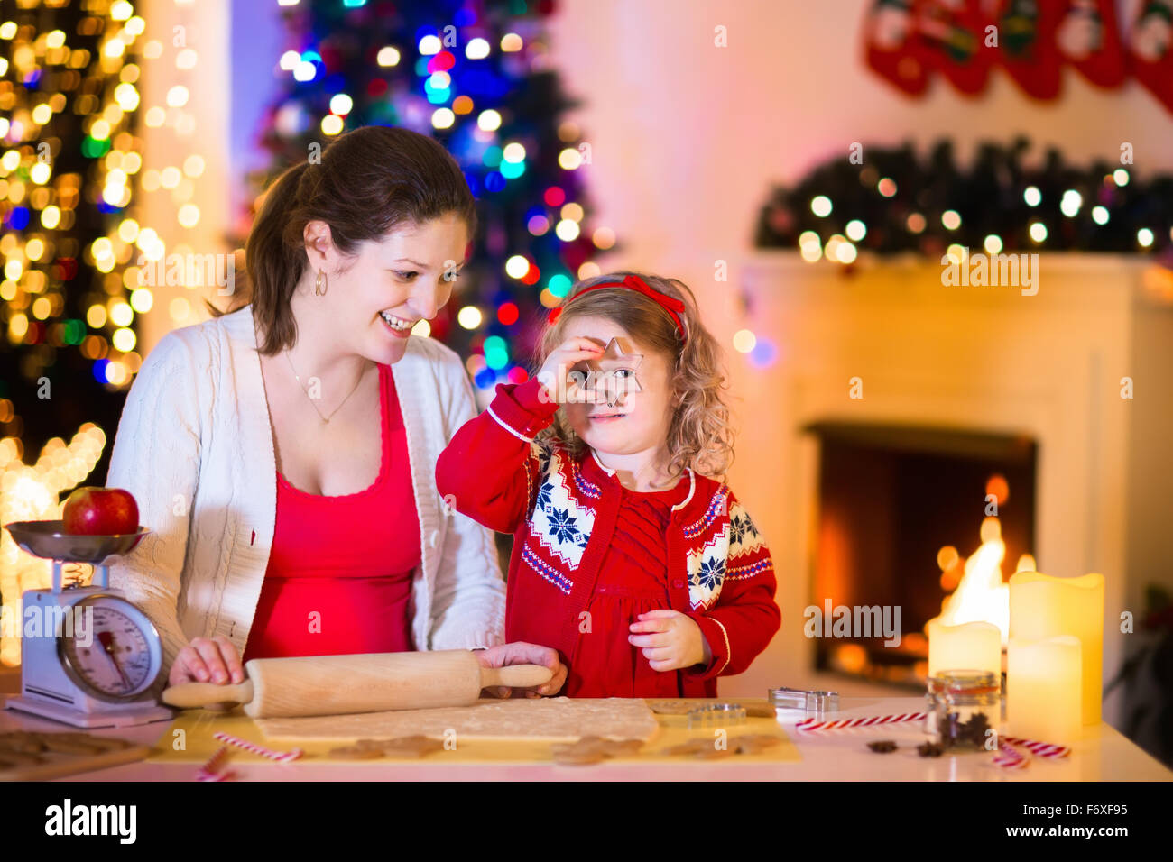 Mother and little girl baking Christmas pastry. Children bake ...