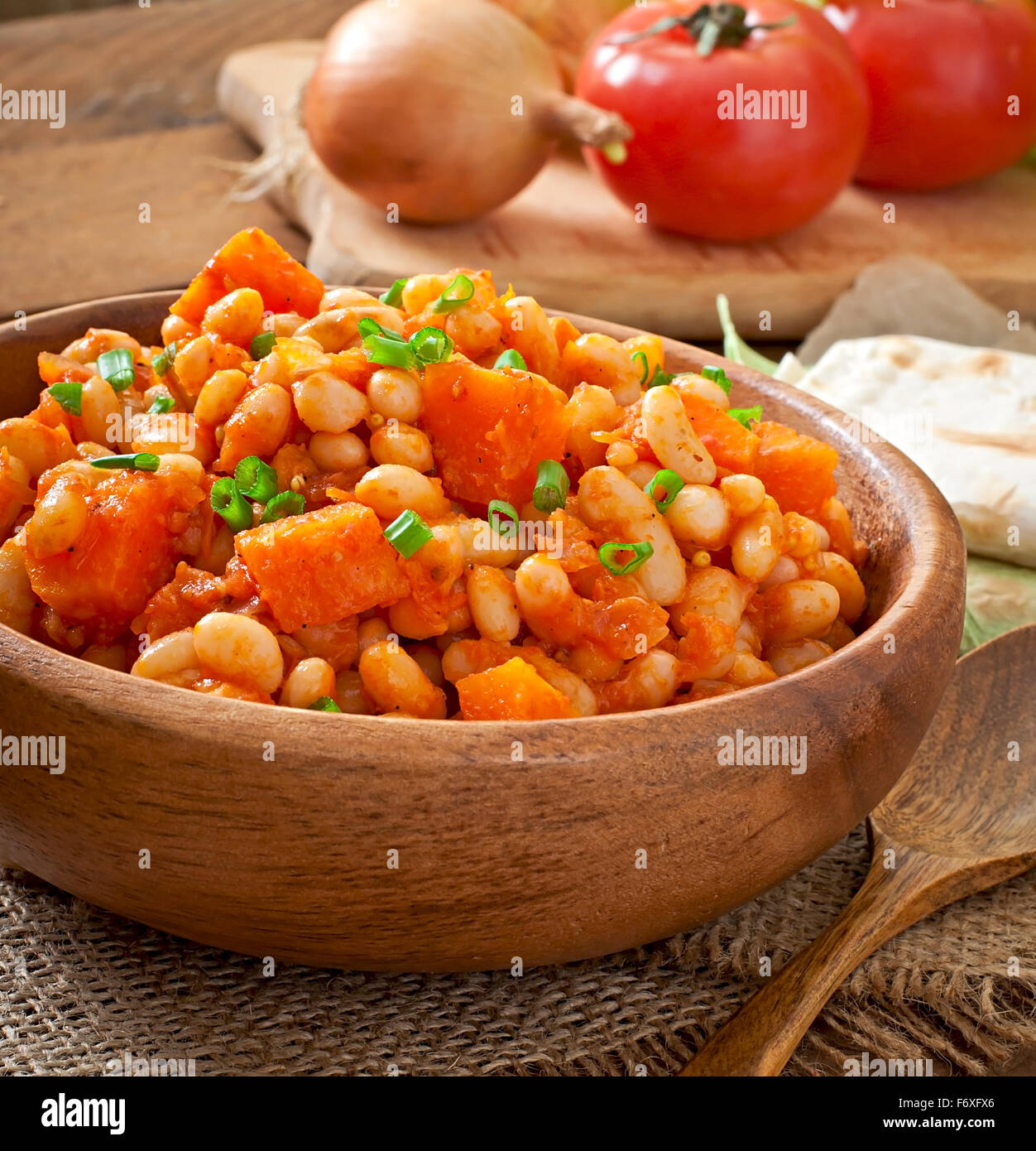 Stewed white beans and sliced pumpkin in tomato sauce Stock Photo - Alamy