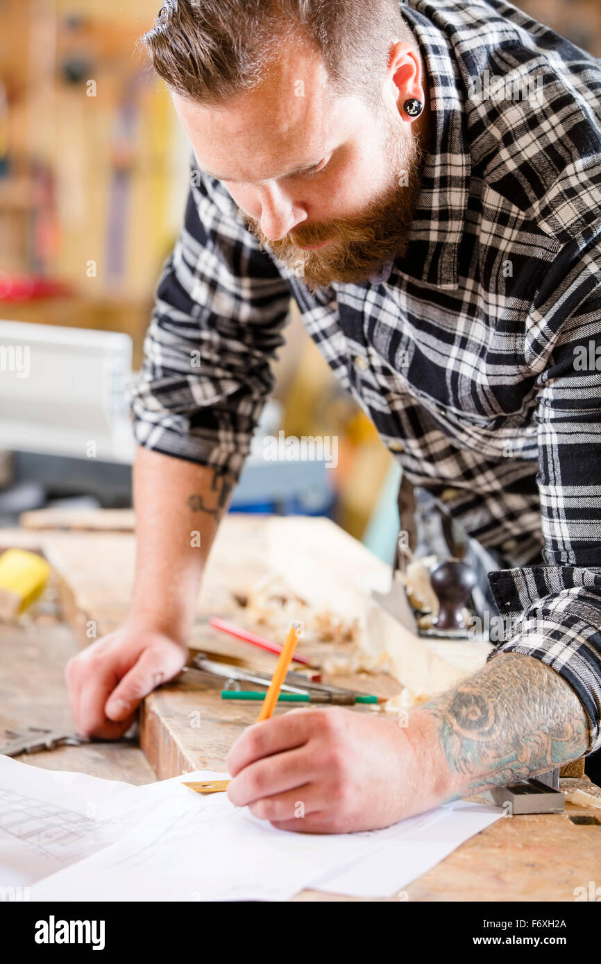Carpenter plans work and notes at project drawings Stock Photo - Alamy