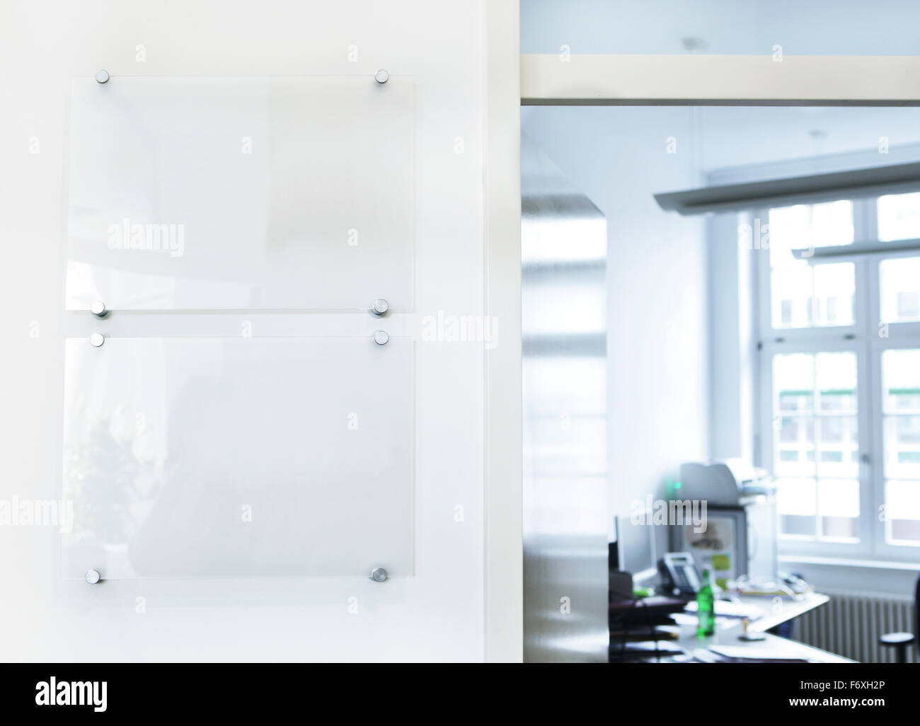 A white office corridor with signs on the wall Stock Photo - Alamy