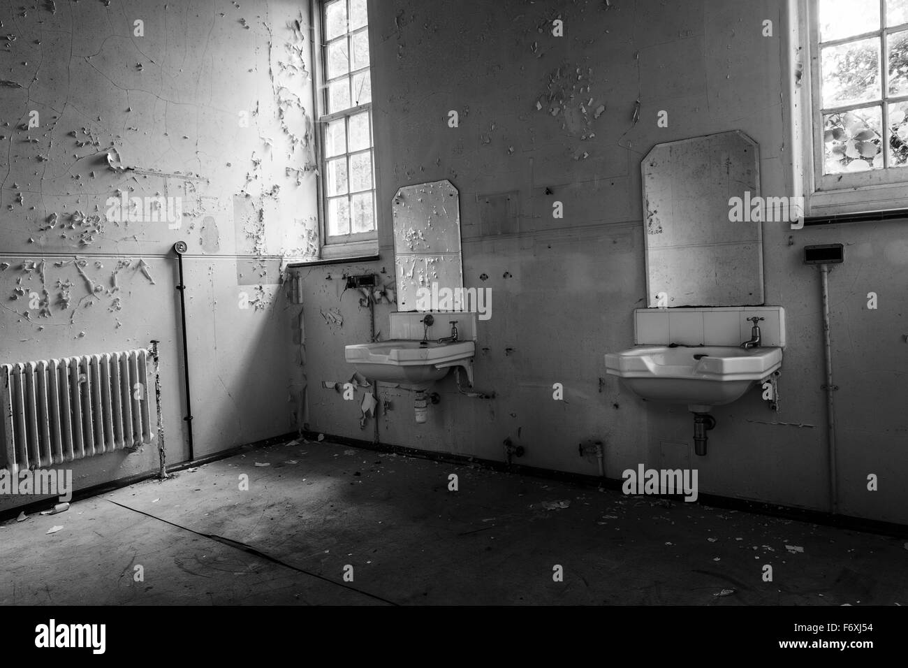 inside view of a deserted run down building showing broken bathroom ...