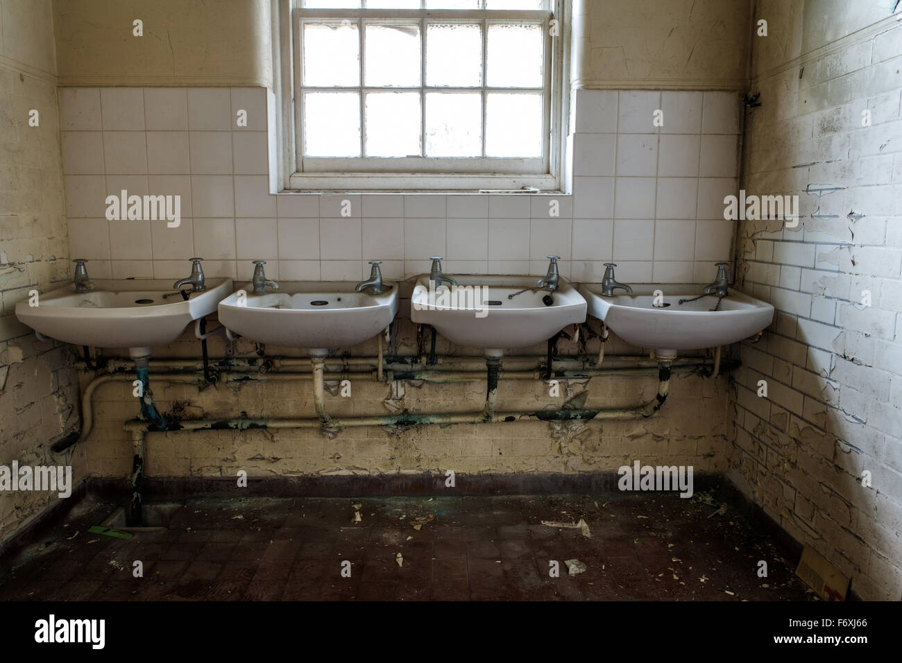 inside view of a deserted run down building showing broken bathroom ...