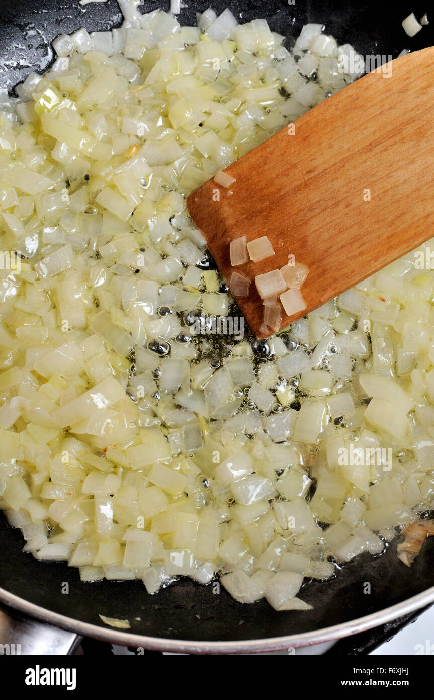 Sliced onions fried in oil. Step by step recipe Stock Photo - Alamy