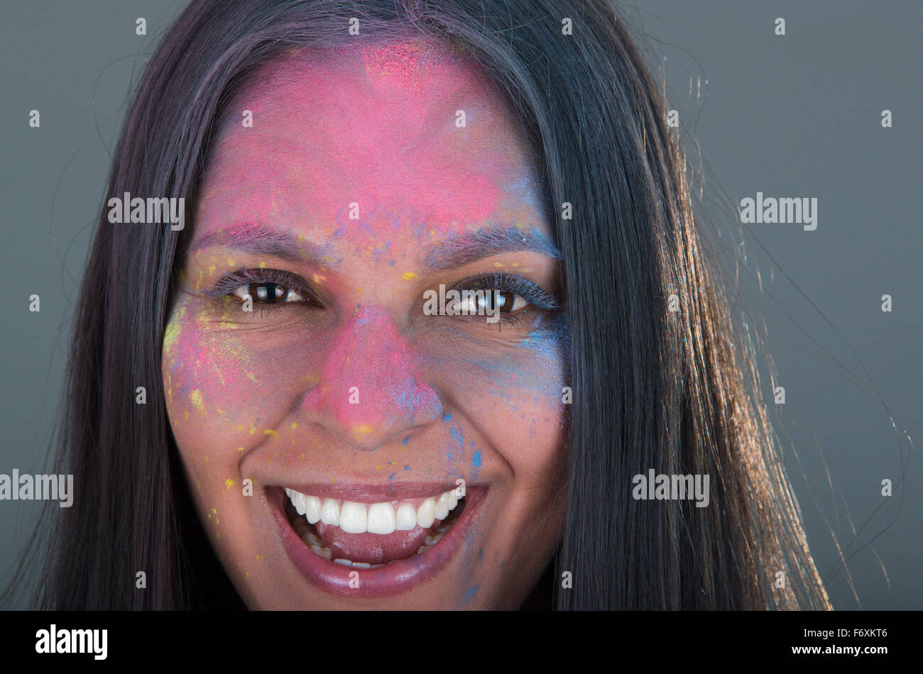 Beautiful young brunette girl with colorful decorated face Stock Photo ...