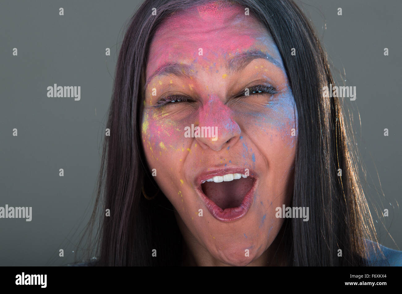 Beautiful young brunette girl with colorful decorated face Stock Photo ...