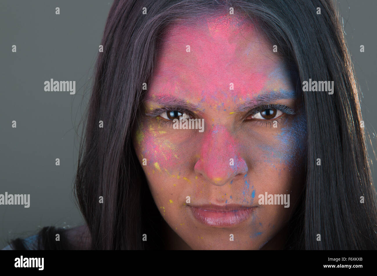 Beautiful young brunette girl with colorful decorated face Stock Photo ...