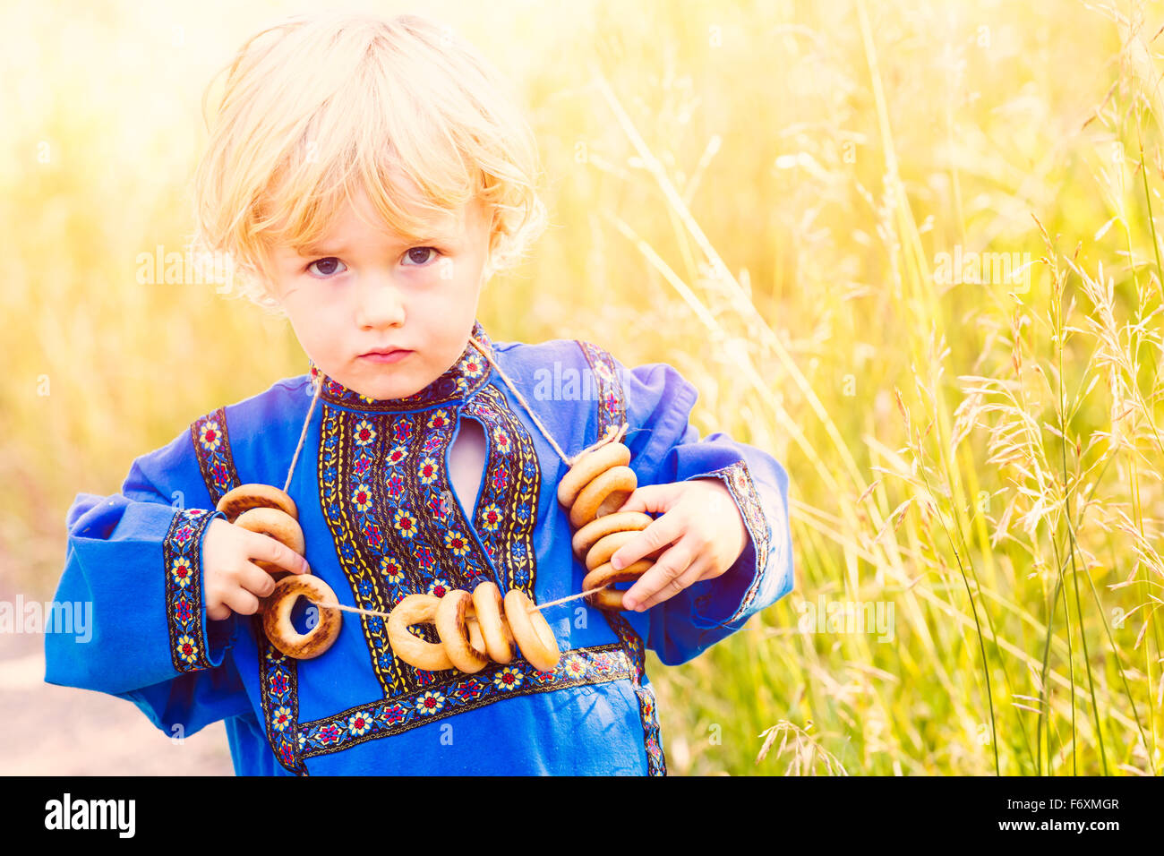 Russian children in traditional Russian costumes playing in the forest ...