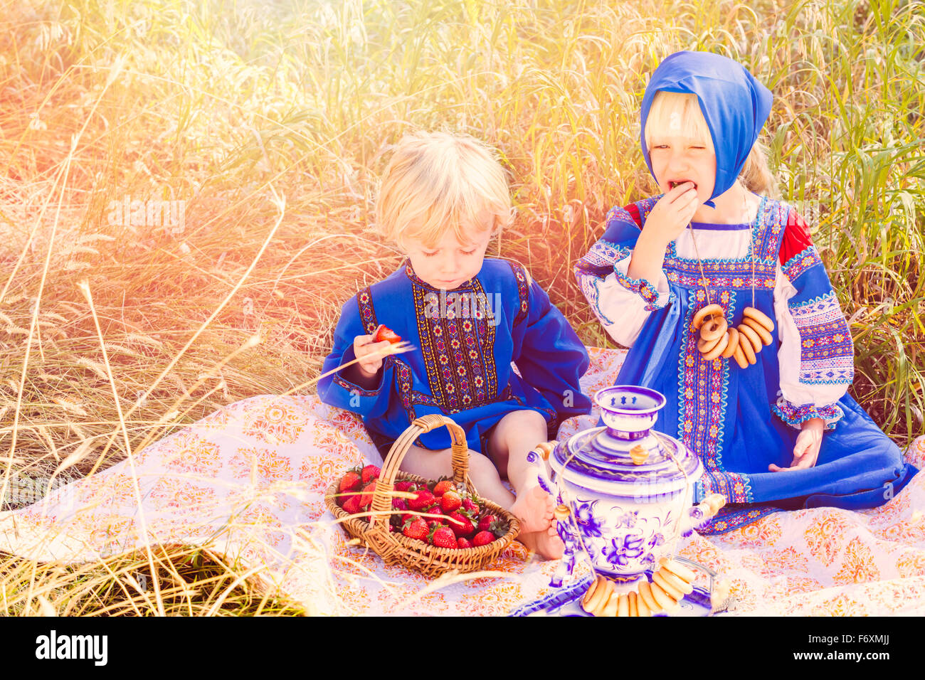 Russian children in traditional Russian costumes playing in the forest ...