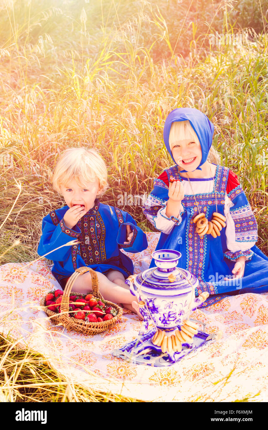 Russian children in traditional Russian costumes playing in the forest ...
