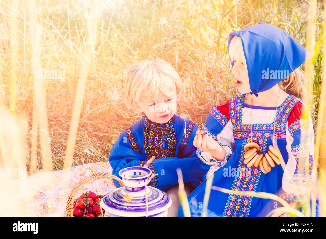 Russian children in traditional Russian costumes playing in the forest ...