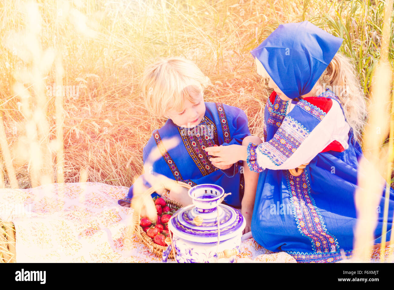 Russian children in traditional Russian costumes playing in the forest ...