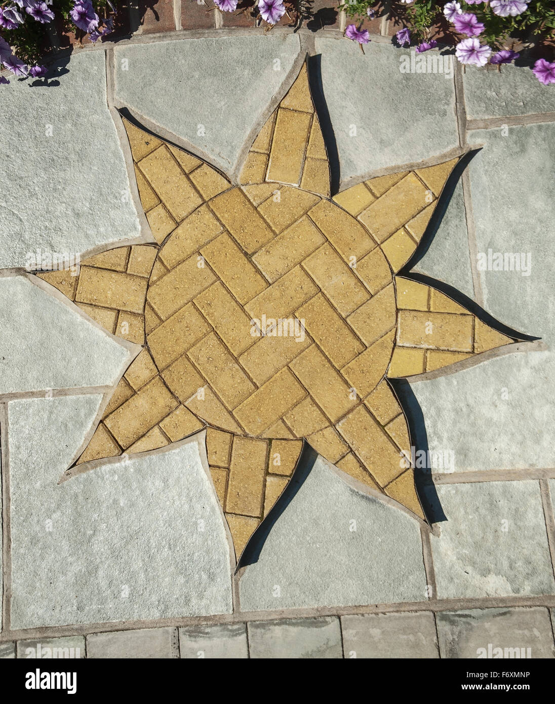 Picture of block paved yellow sun Stock Photo - Alamy