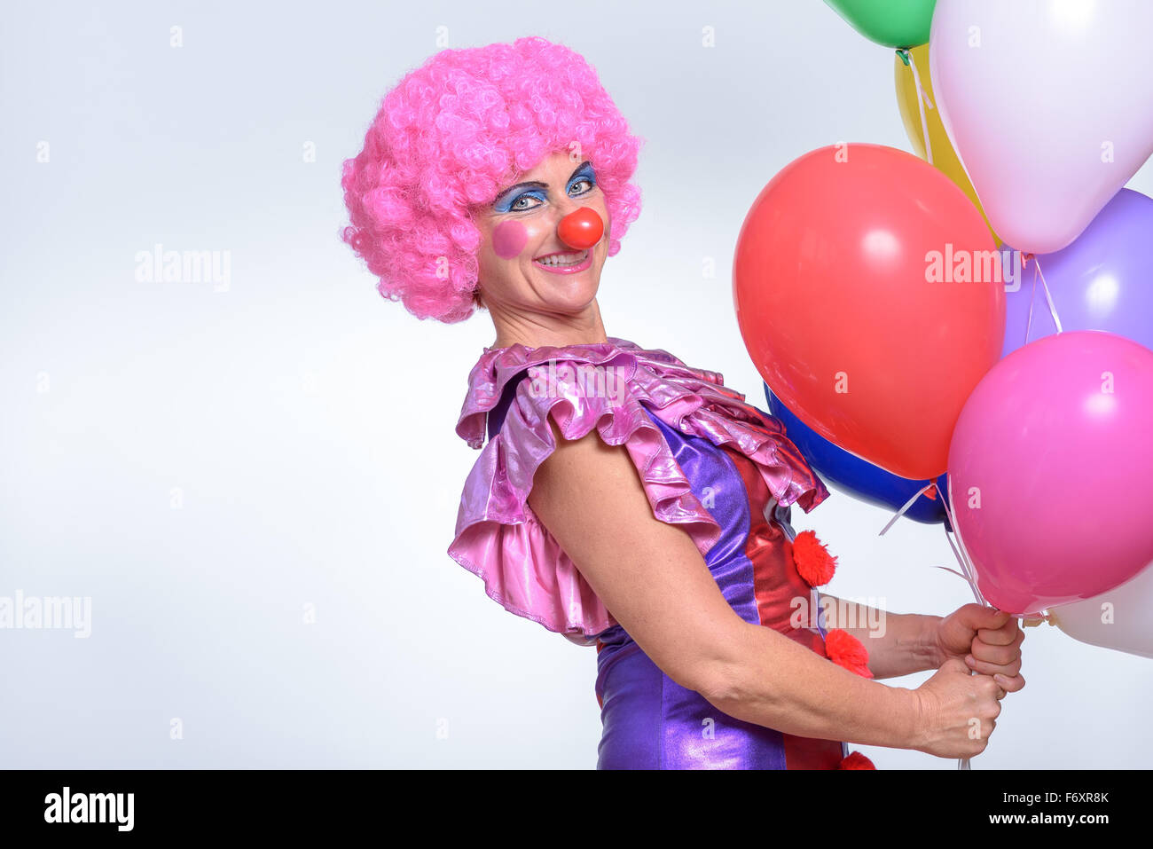 Half Body Shot of a Female Clown with Colored Balloons, Smiling at the ...