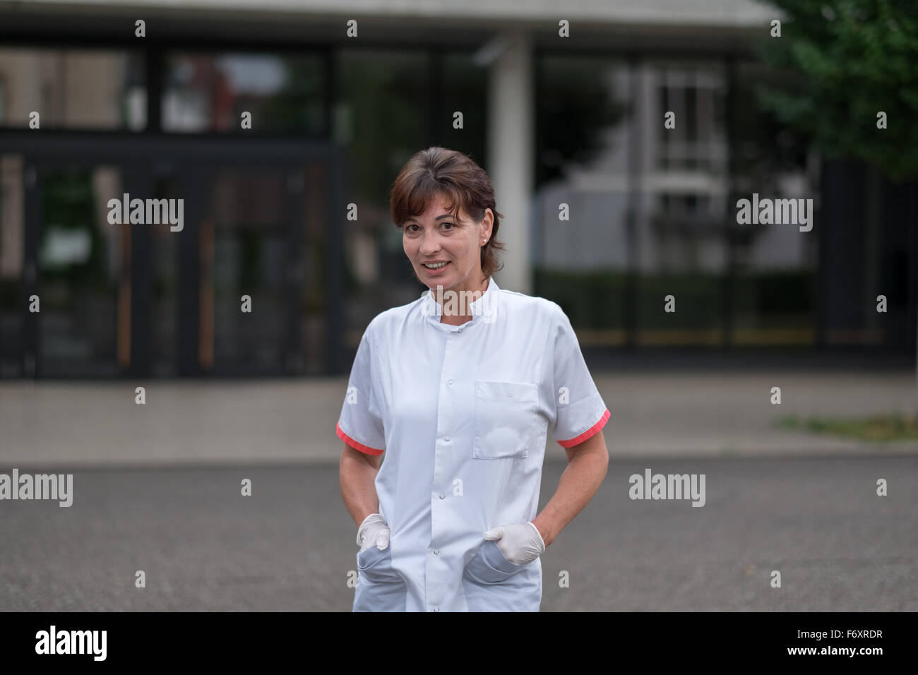Half Body Shot of a Young Female Nurse Standing Outside the Hospital ...