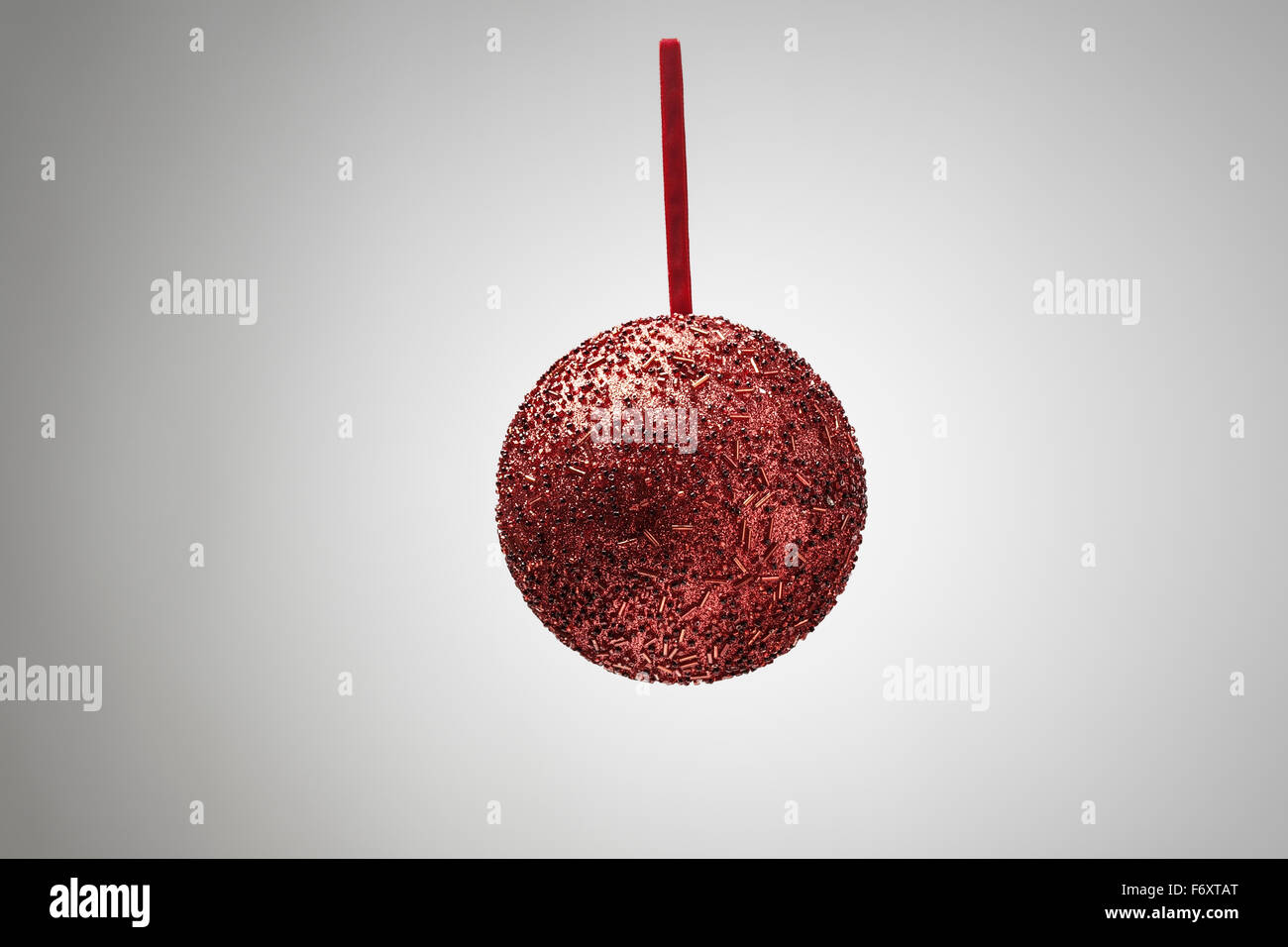 single christmas ball hanging on ribbon, white background shot in the ...