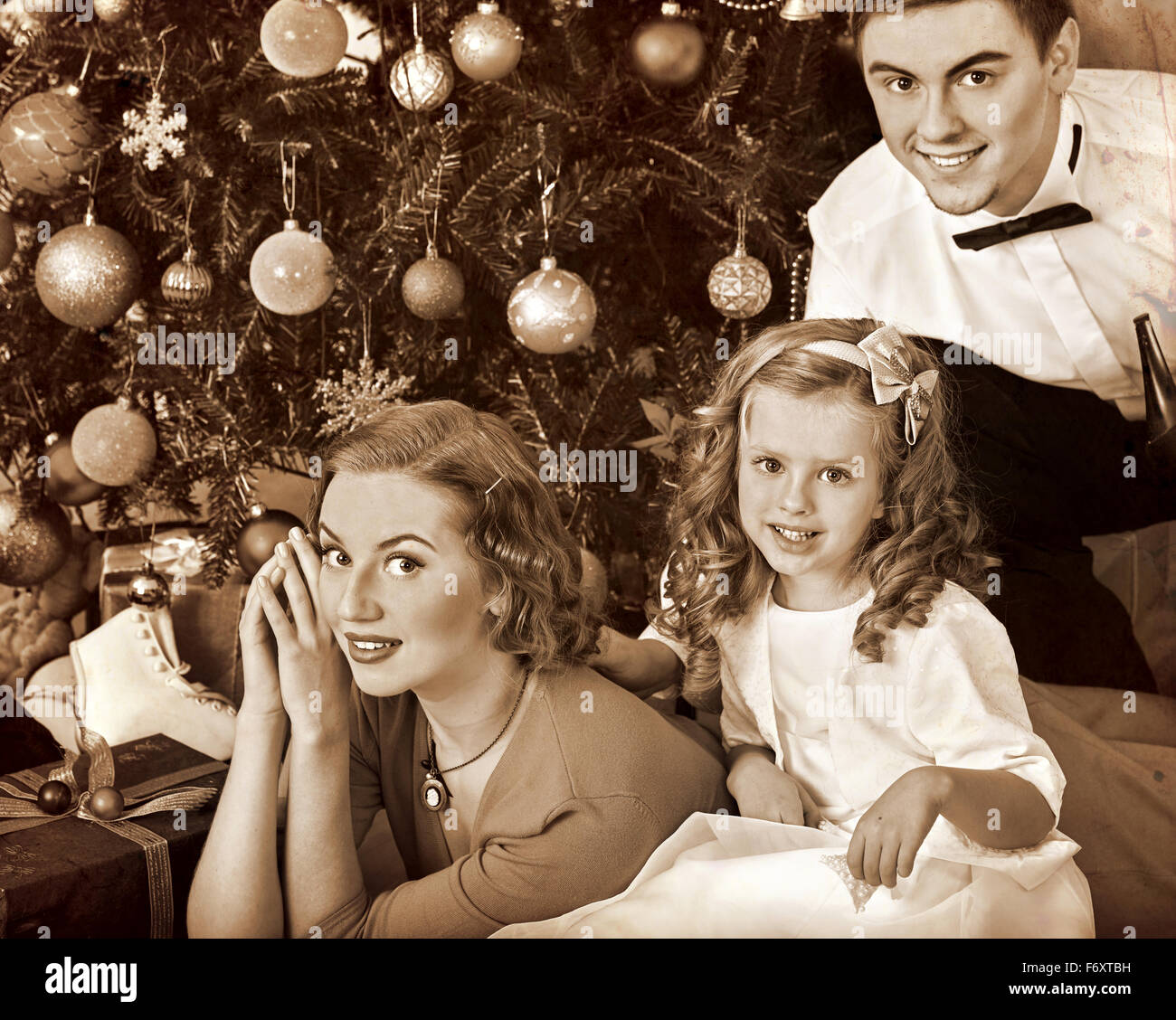 Family with children dressing Christmas tree Stock Photo - Alamy