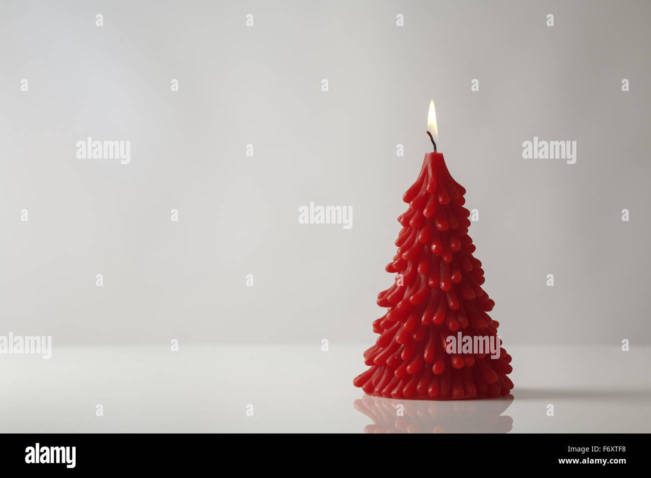 burning candle in the shape of a christmas tree Stock Photo - Alamy
