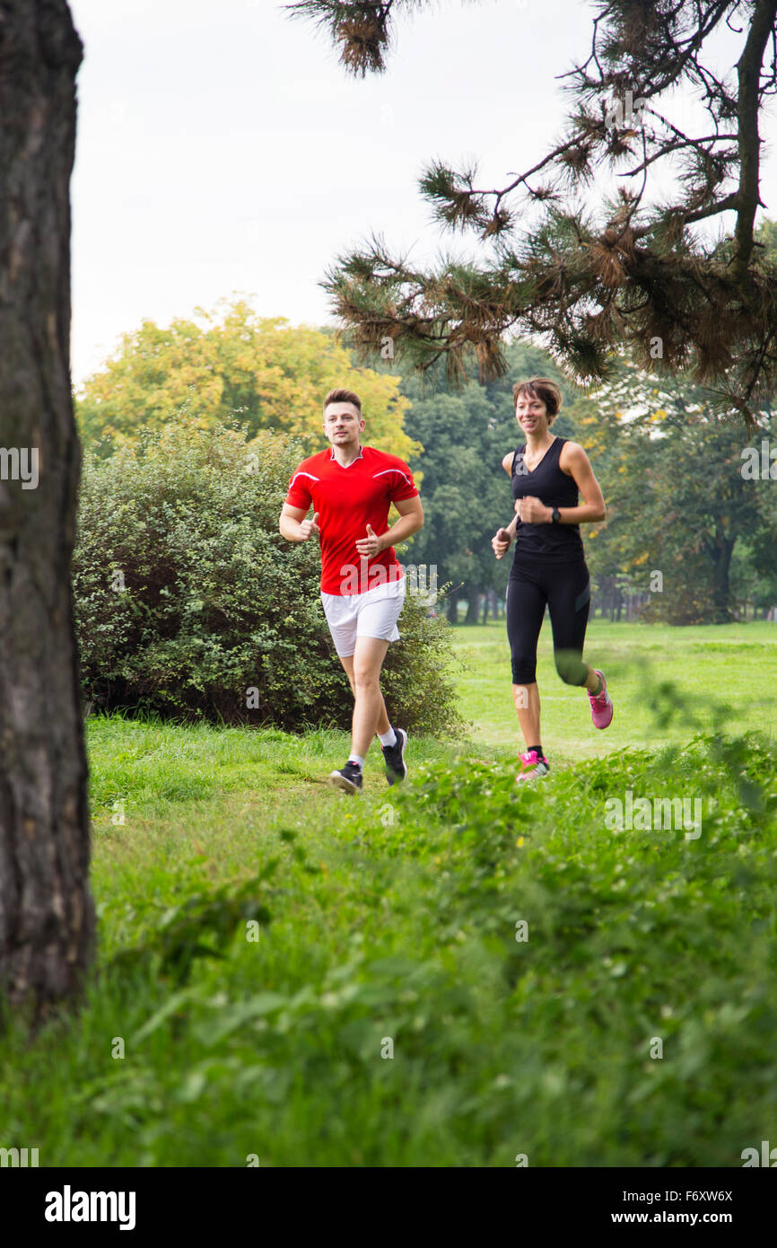 Young people running in the park Stock Photo - Alamy