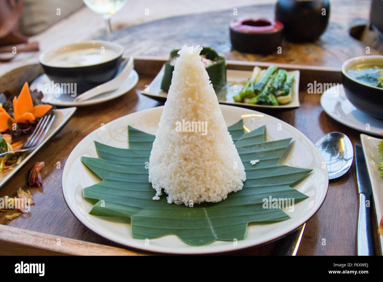 Cone of rice served on banana leaf Stock Photo - Alamy