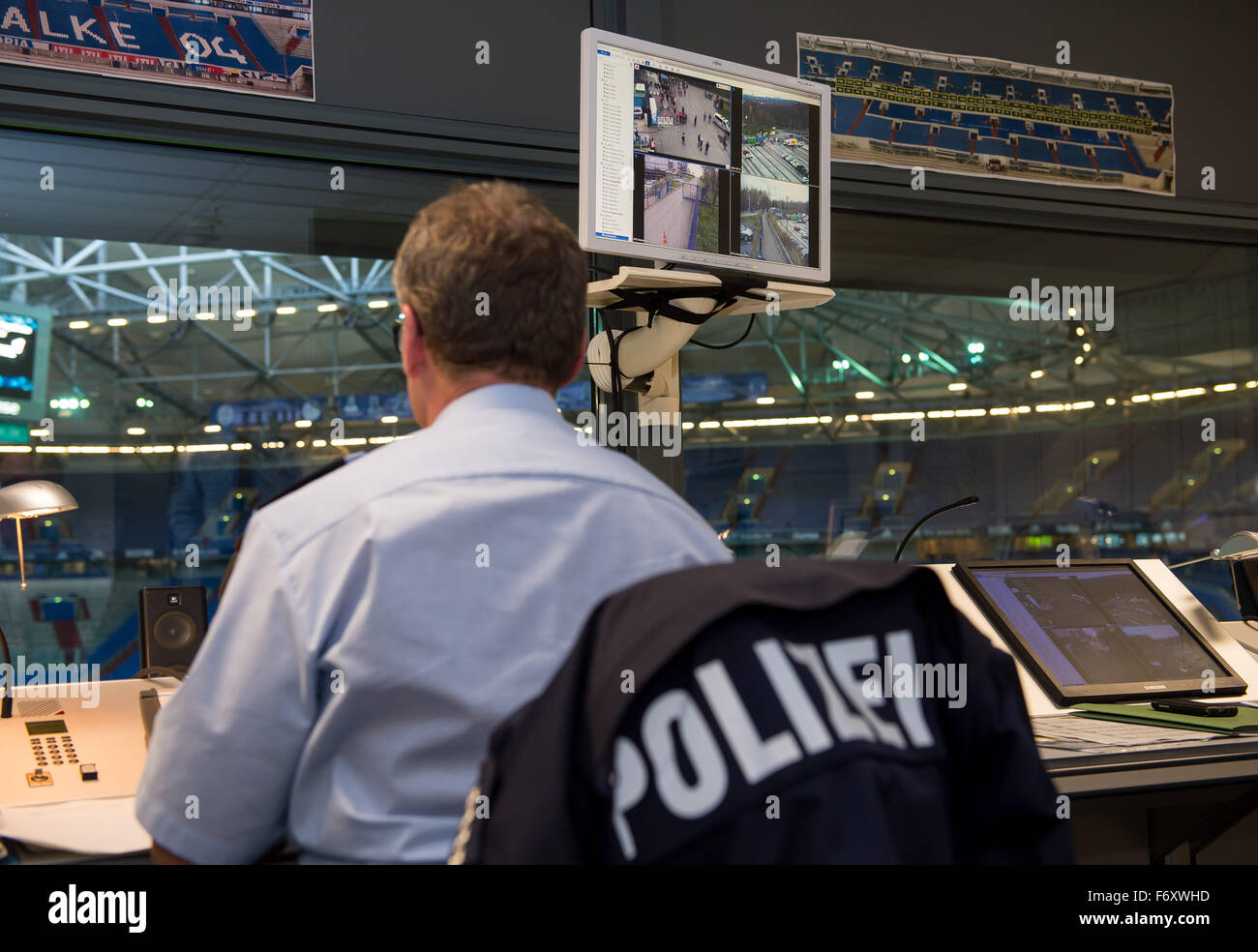 Gelsenkirchen, Germany. 21st Nov, 2015. A police officer sits in the ...