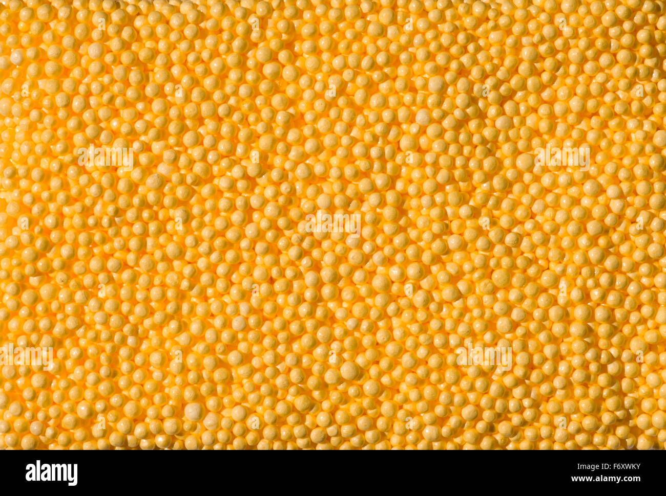 A background from little orange pellets Stock Photo - Alamy